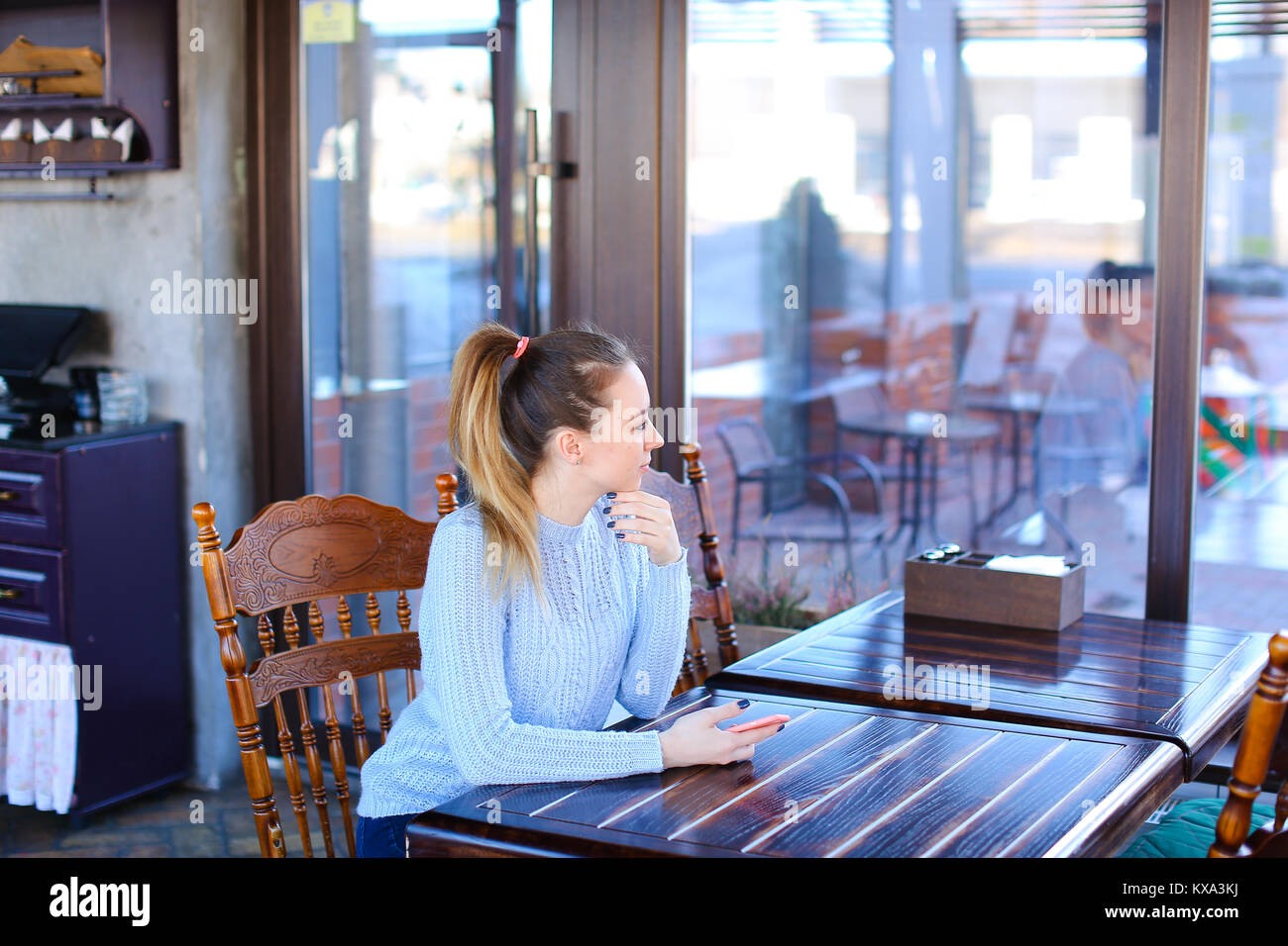 Model waiting photographer for photoshoot in cafe Stock Photo - Alamy