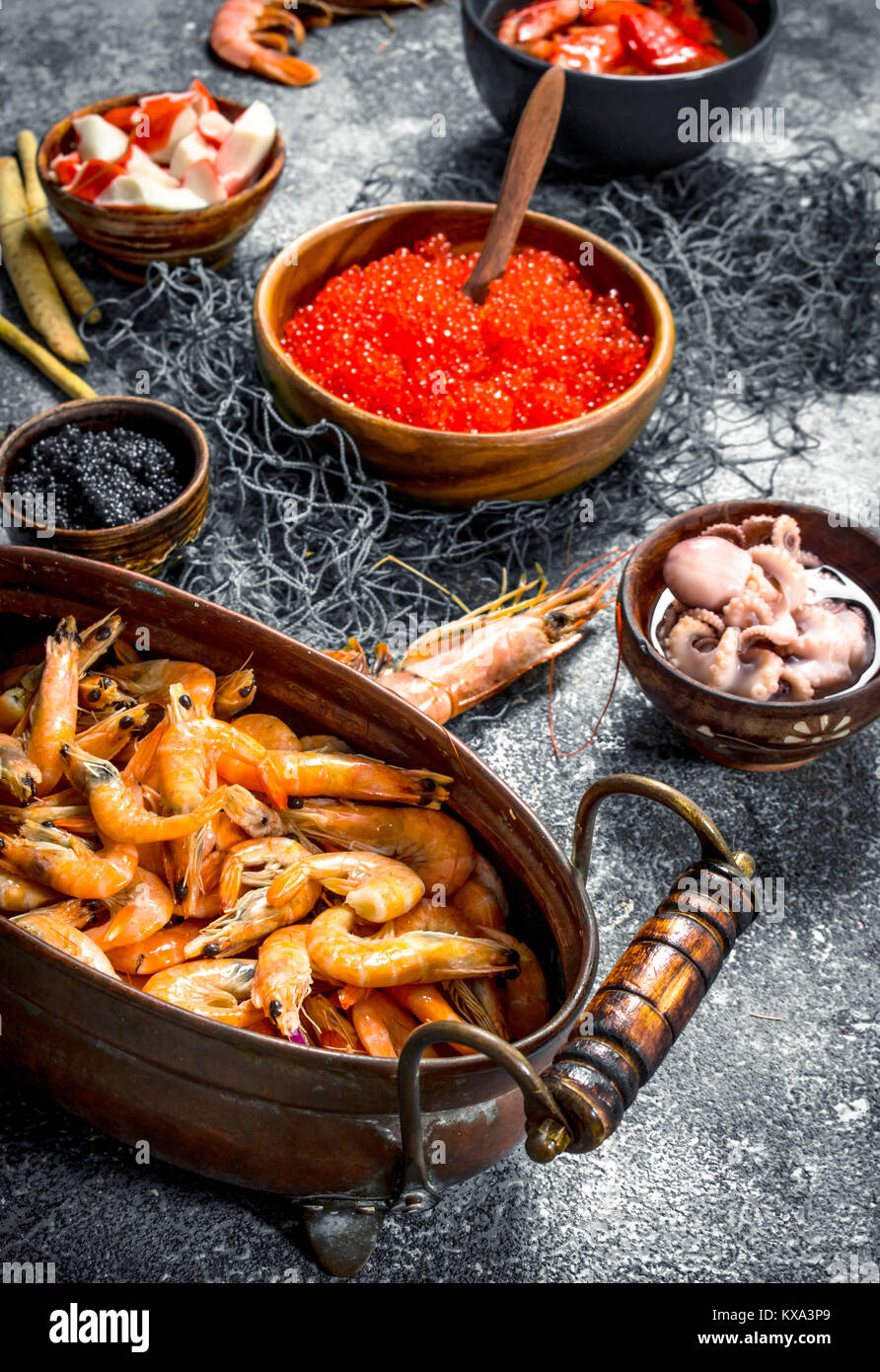 Different fresh seafood. On a rustic background Stock Photo - Alamy