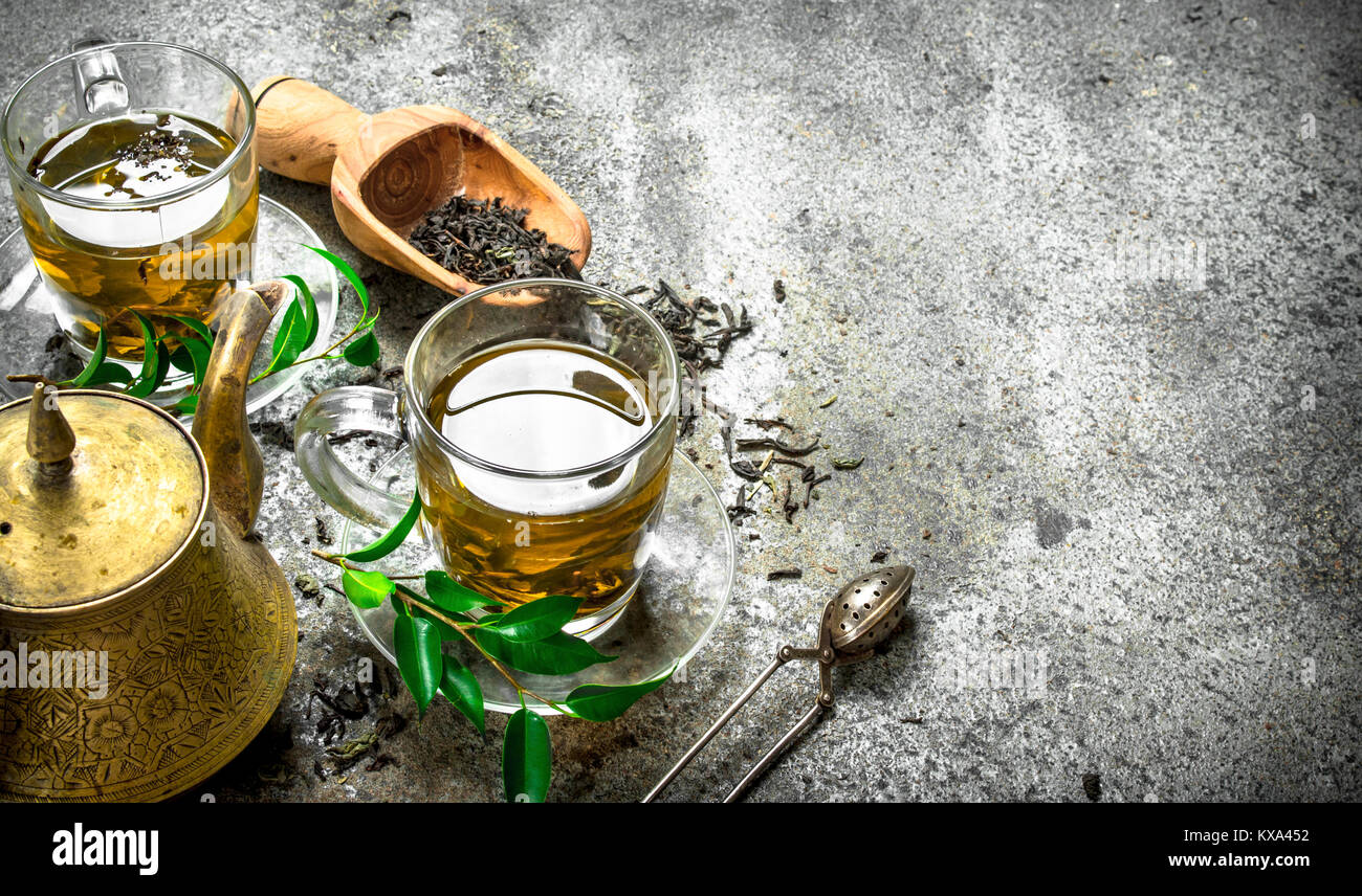 Fresh Indian tea with a brewer. On a rustic background Stock Photo - Alamy