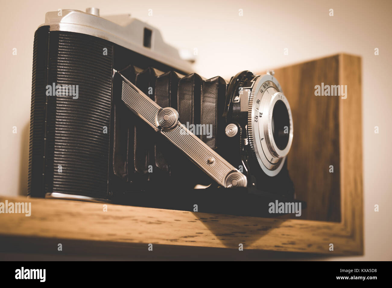 Old fashioned photography camera on wooden shelf, effects applied Stock ...