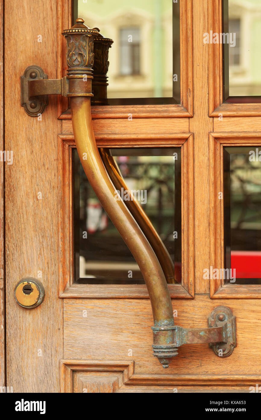 Wooden door handle has a curved shape Stock Photo - Alamy