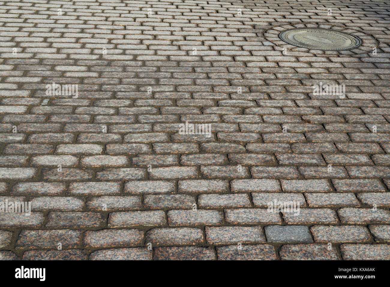 Paved street of the city.With a metal hatch for waste water Stock Photo ...