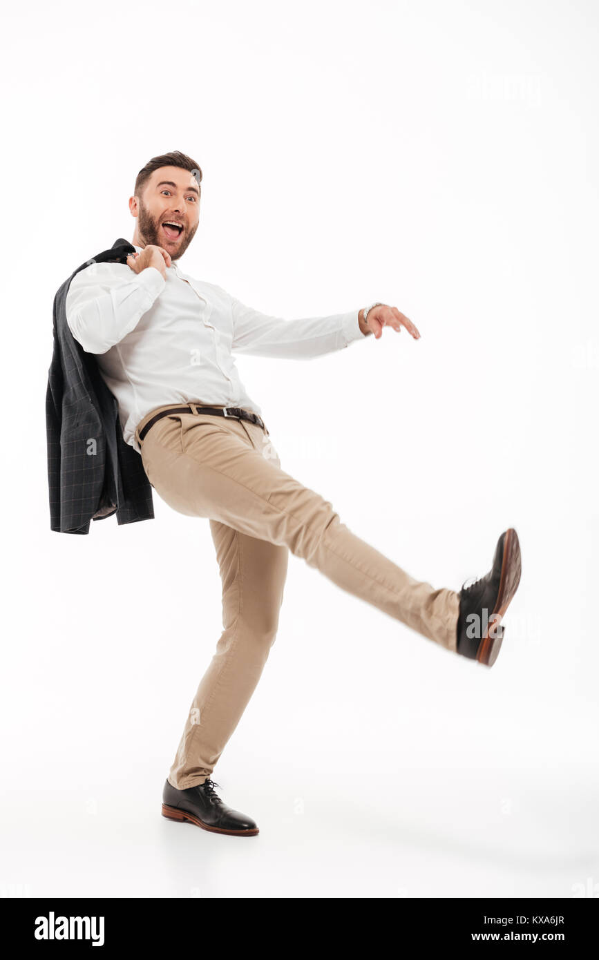 Full length portrait of a happy cheerful man holding jacket over his ...