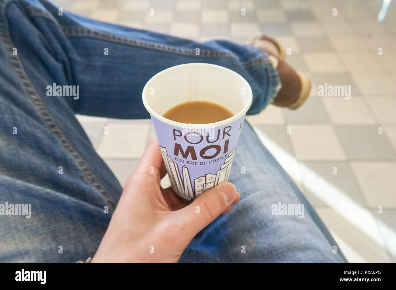 Man in a waiting room with a cup of white coffee in his hand Stock ...