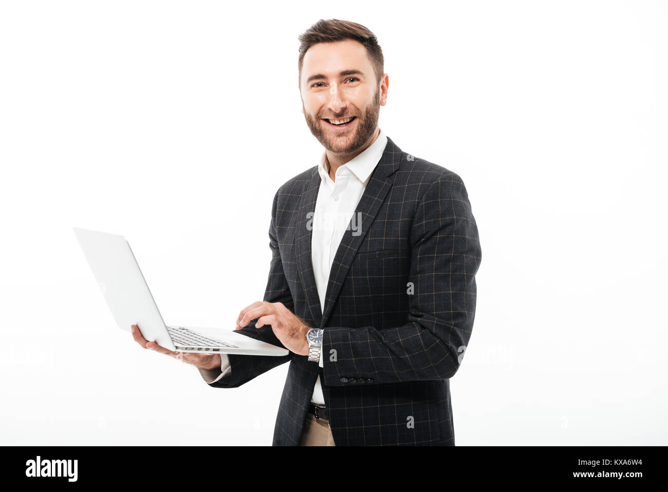 Portrait of a smiling bearded man holding laptop computer and looking ...