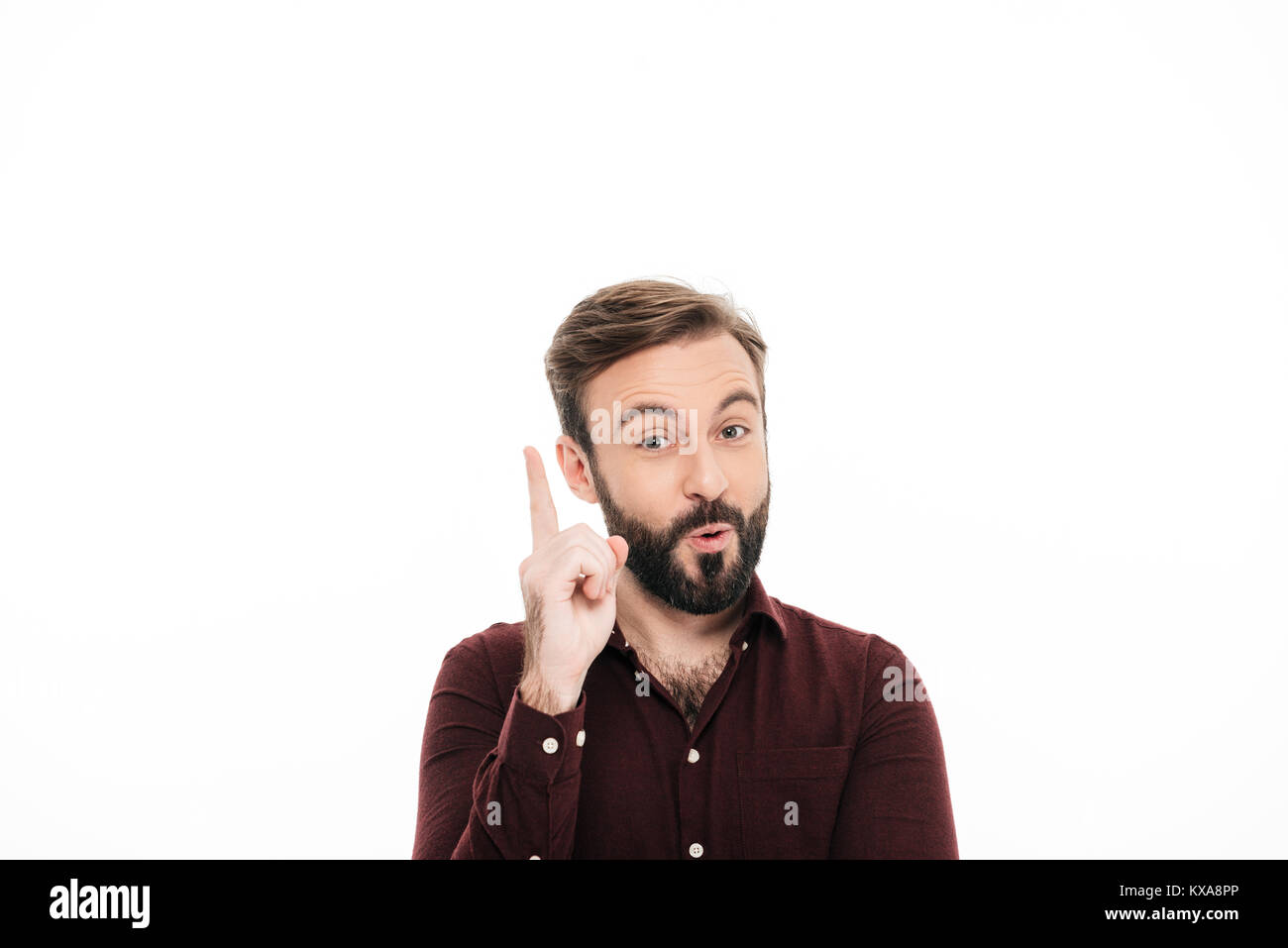 Portrait of an excited happy man having an idea and pointing finger up ...