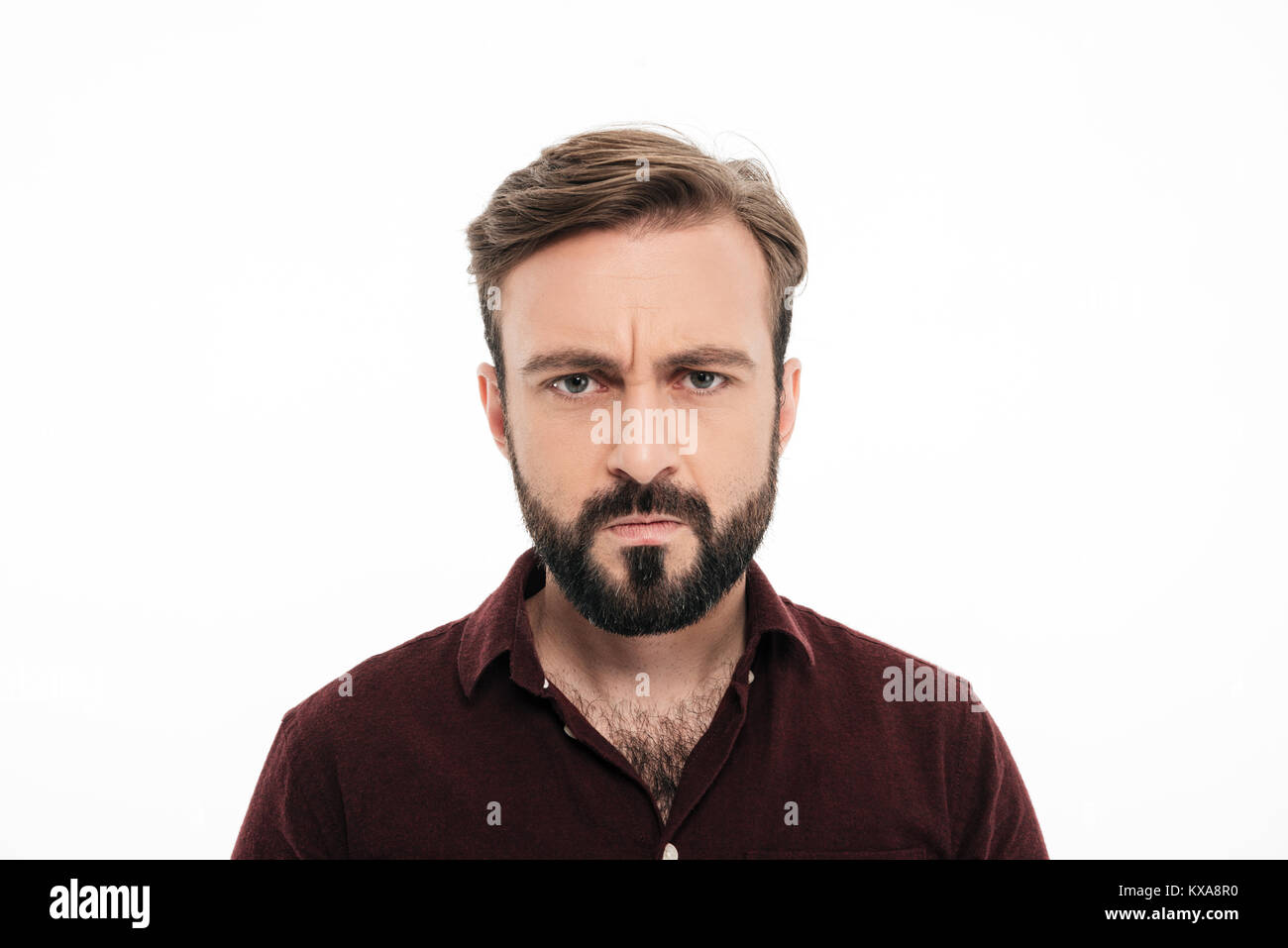 Close up portrait of frowning angry bearded man staring at camera ...