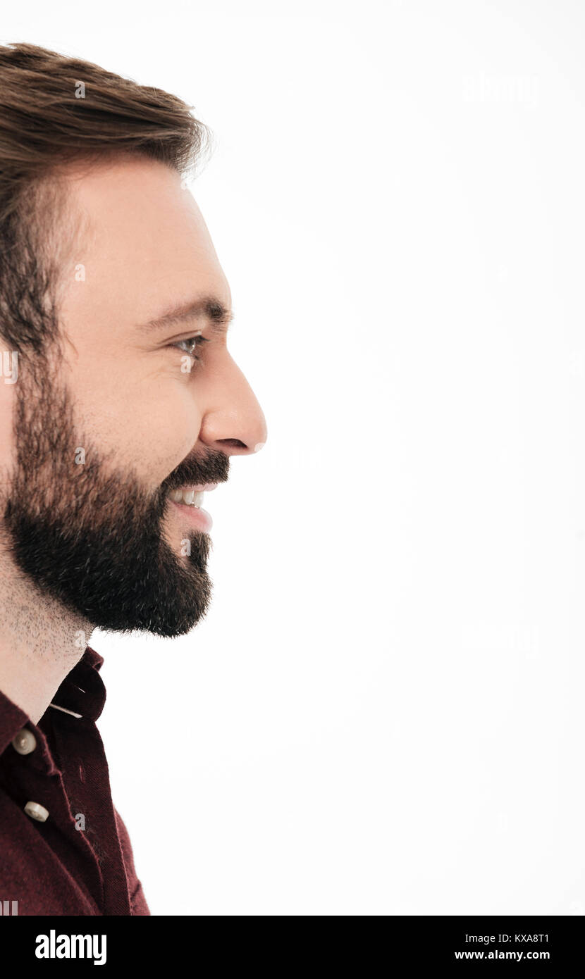 Side view half face portrait of a smiling bearded man laughing and ...