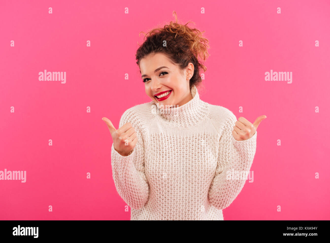 Portrait of a cheery happy girl showing two thumbs up isolated over ...