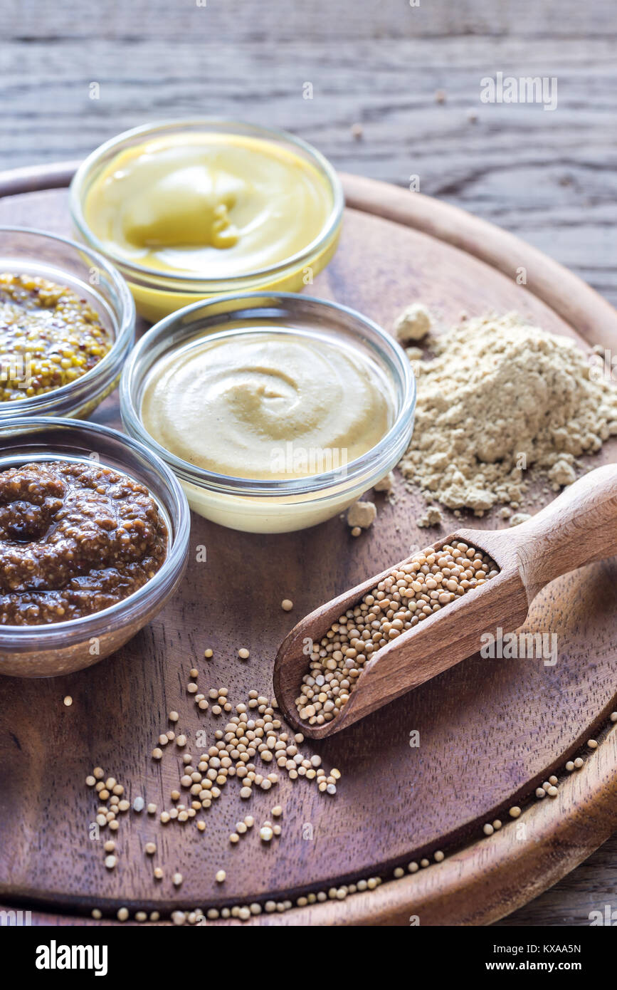 Different kinds of mustard on the wooden background Stock Photo - Alamy