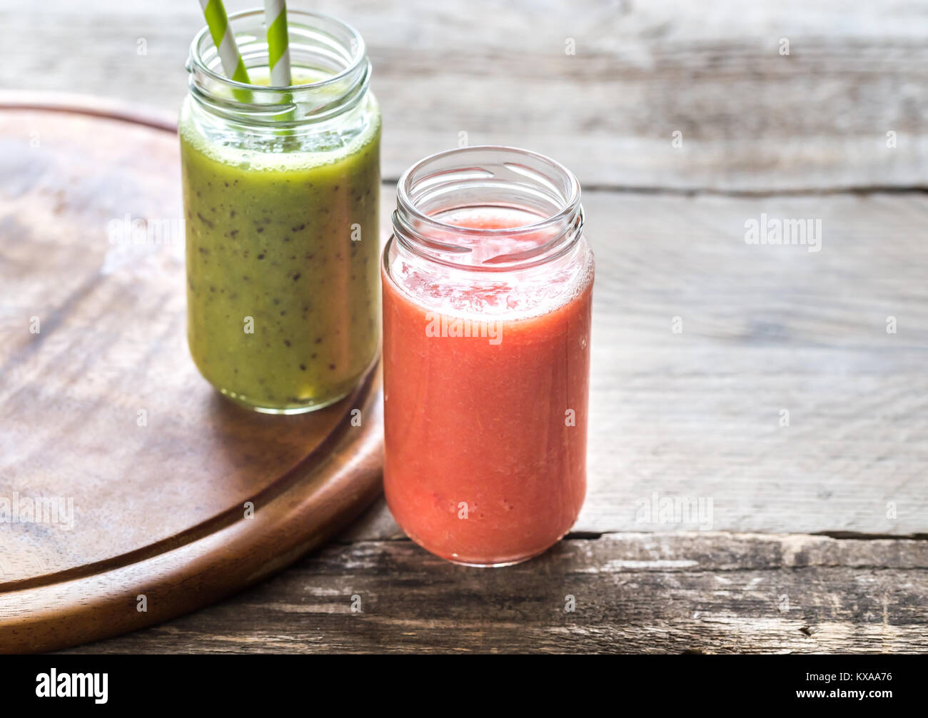 Glass jars of fruit smoothies Stock Photo - Alamy