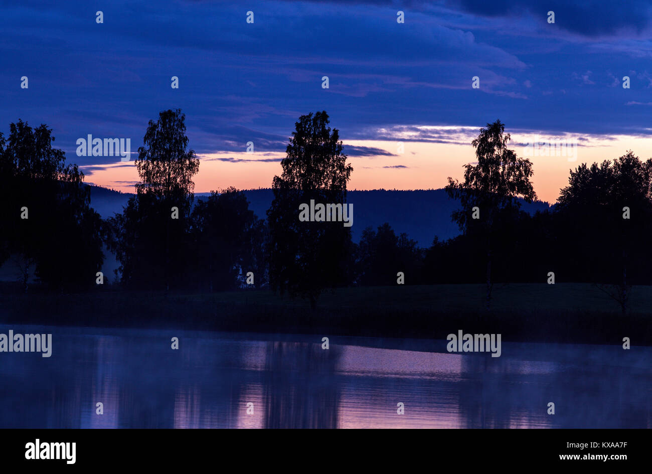 Nightfall above a lake. Summer night up North. Forest and hills Stock ...