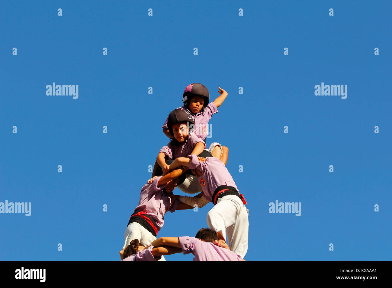 People making human towers, a traditional spectacle in Catalonia called ...