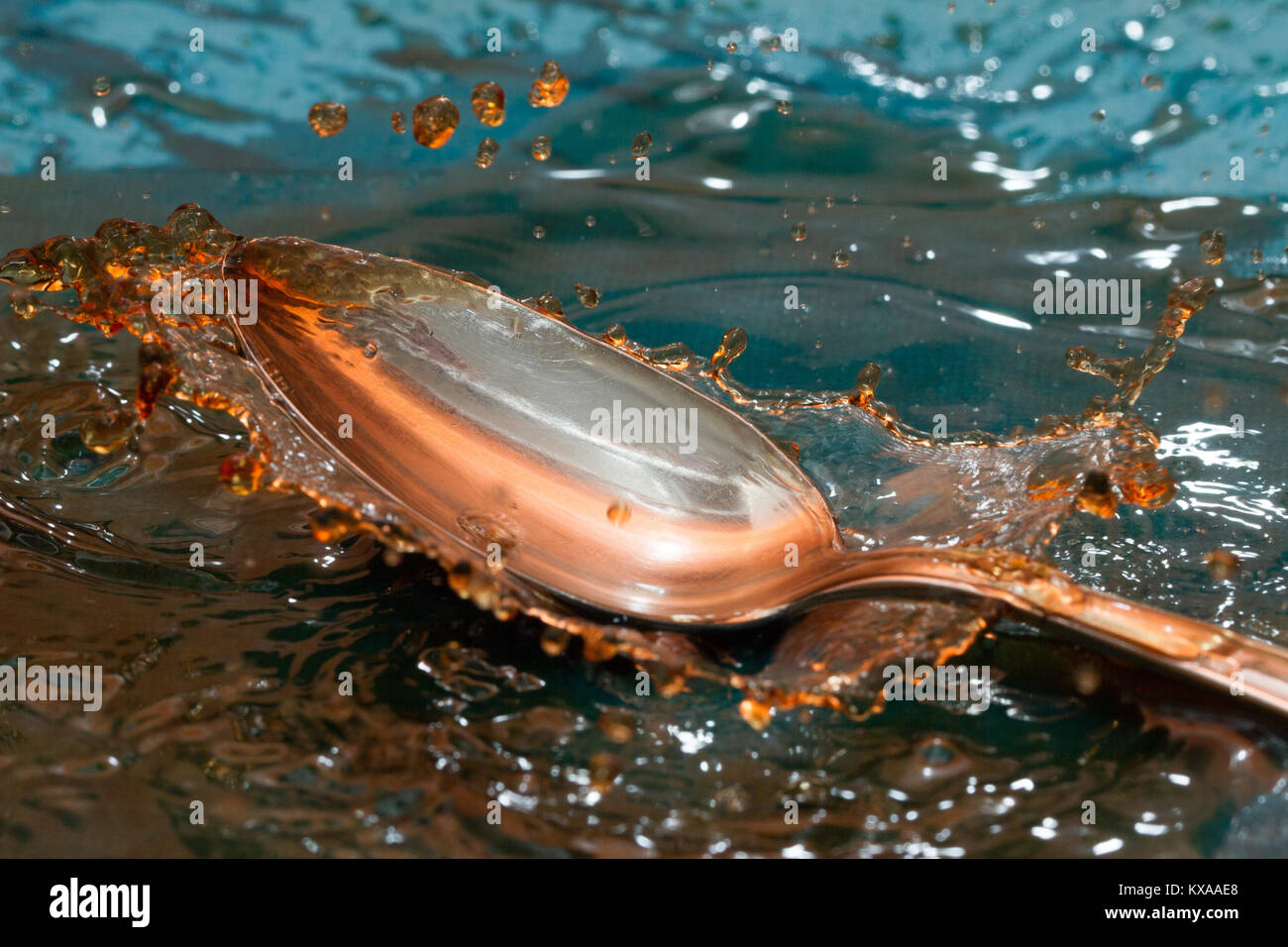 Splash on Spoon Stock Photo - Alamy