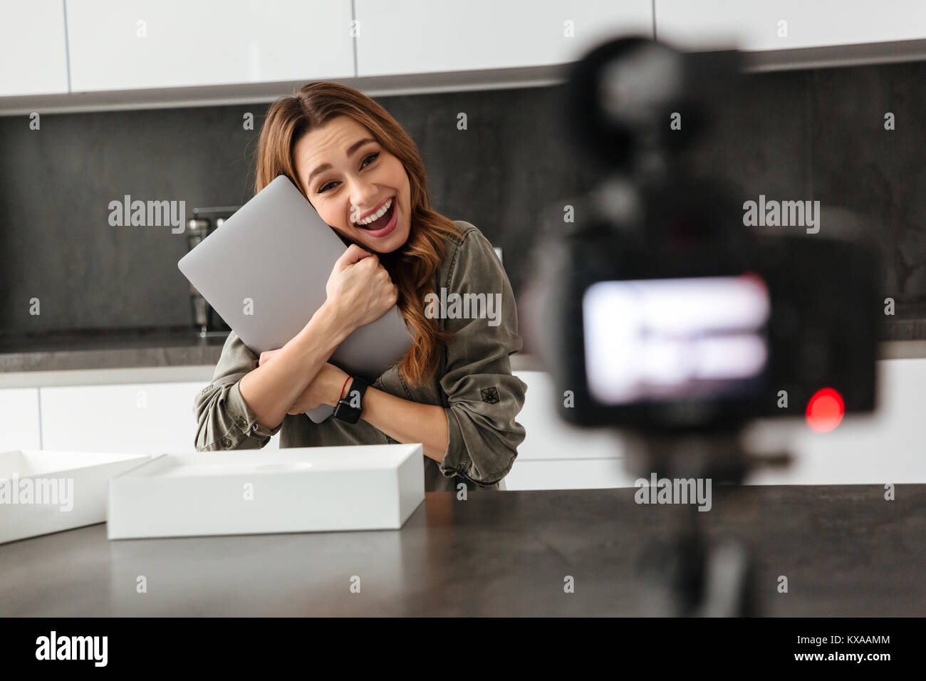 Lovely young girl recording video blog episode about new tech devices ...