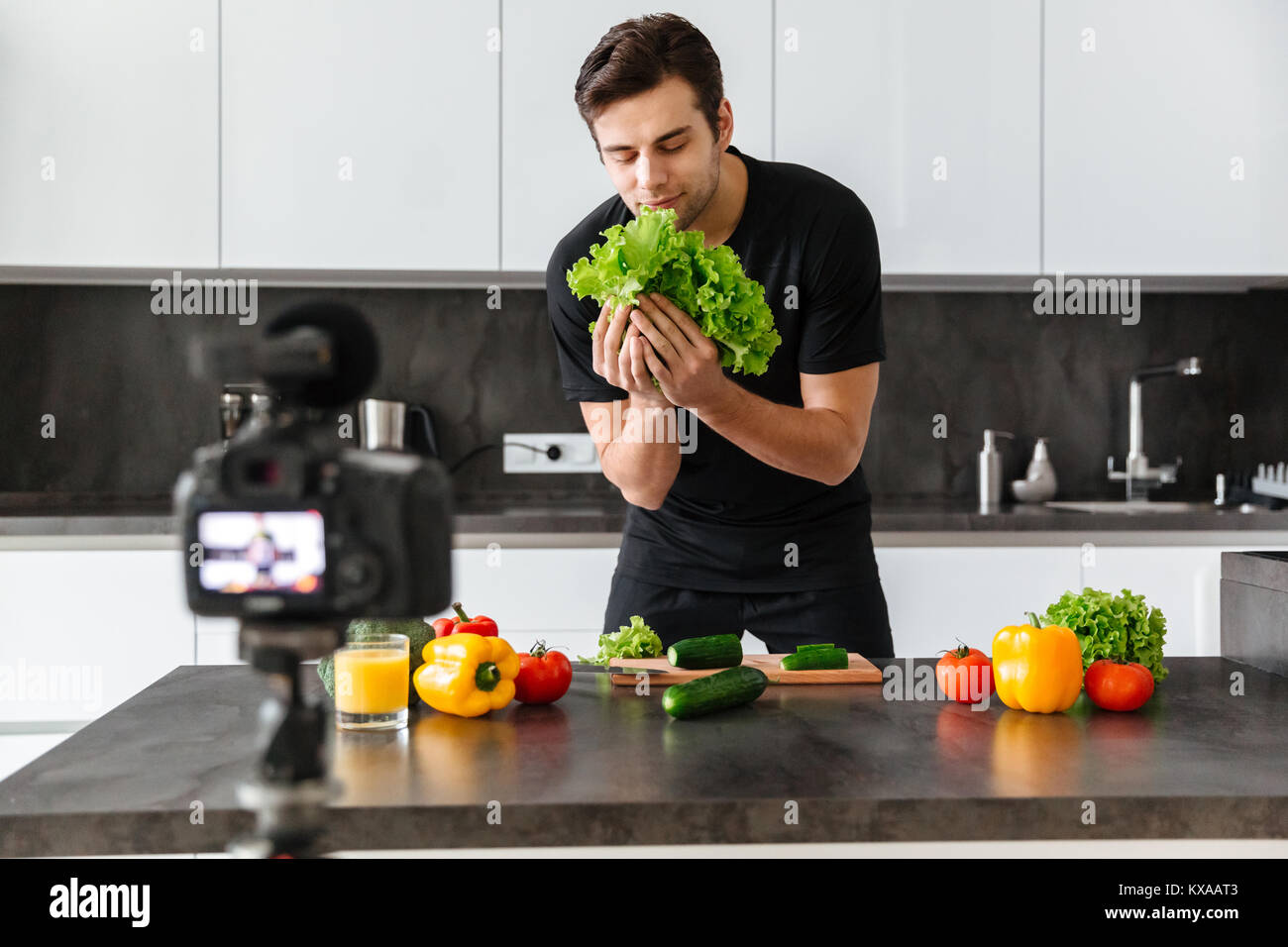 Handsome young man filming his video blog episode about healthy food ...