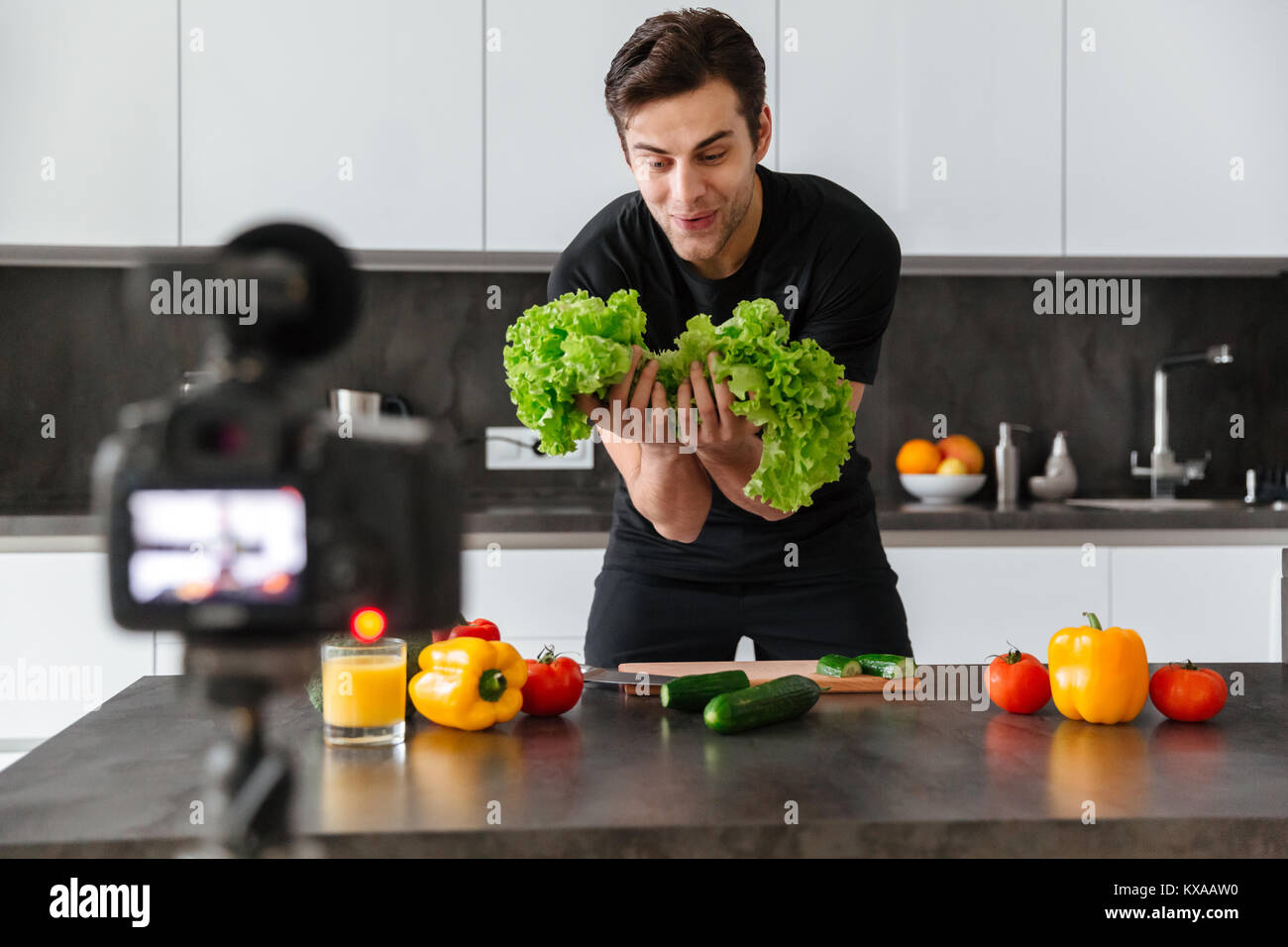 Excited young man filming his video blog episode about healthy food ...