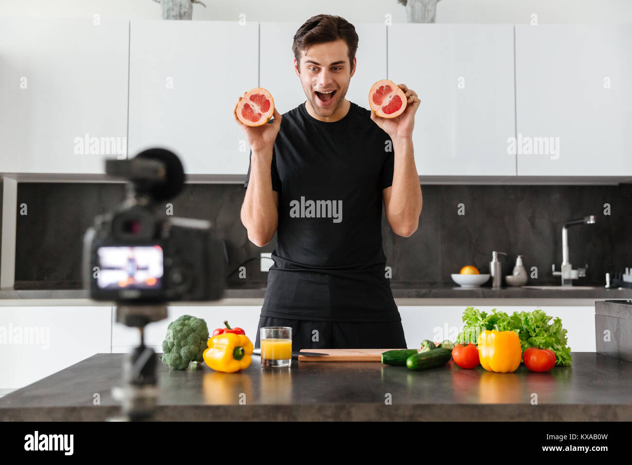Excited young man filming his video blog episode about healthy food ...