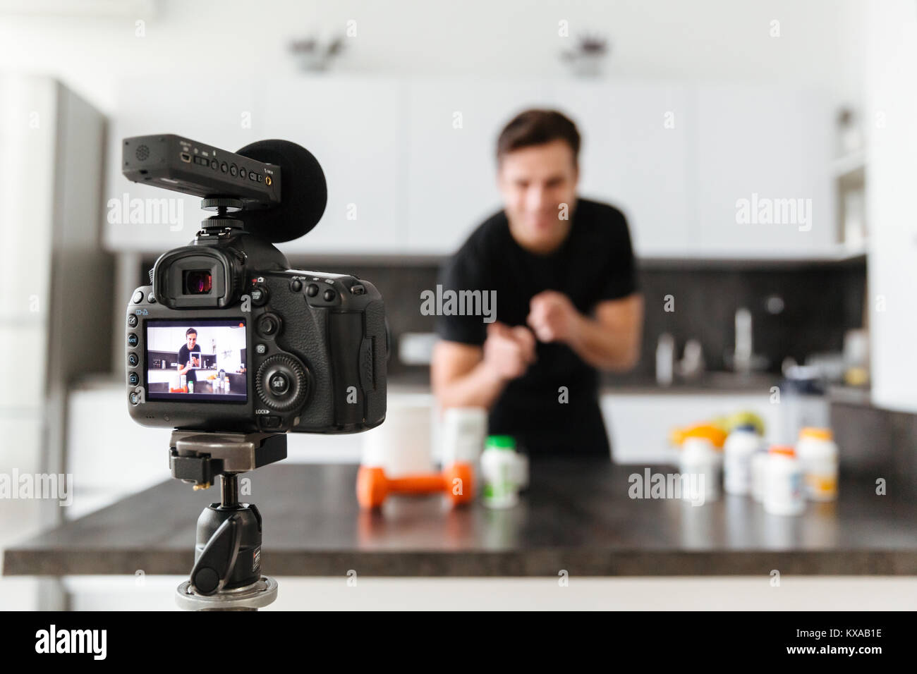 Happy young man filming his video blog episode about healthy food ...