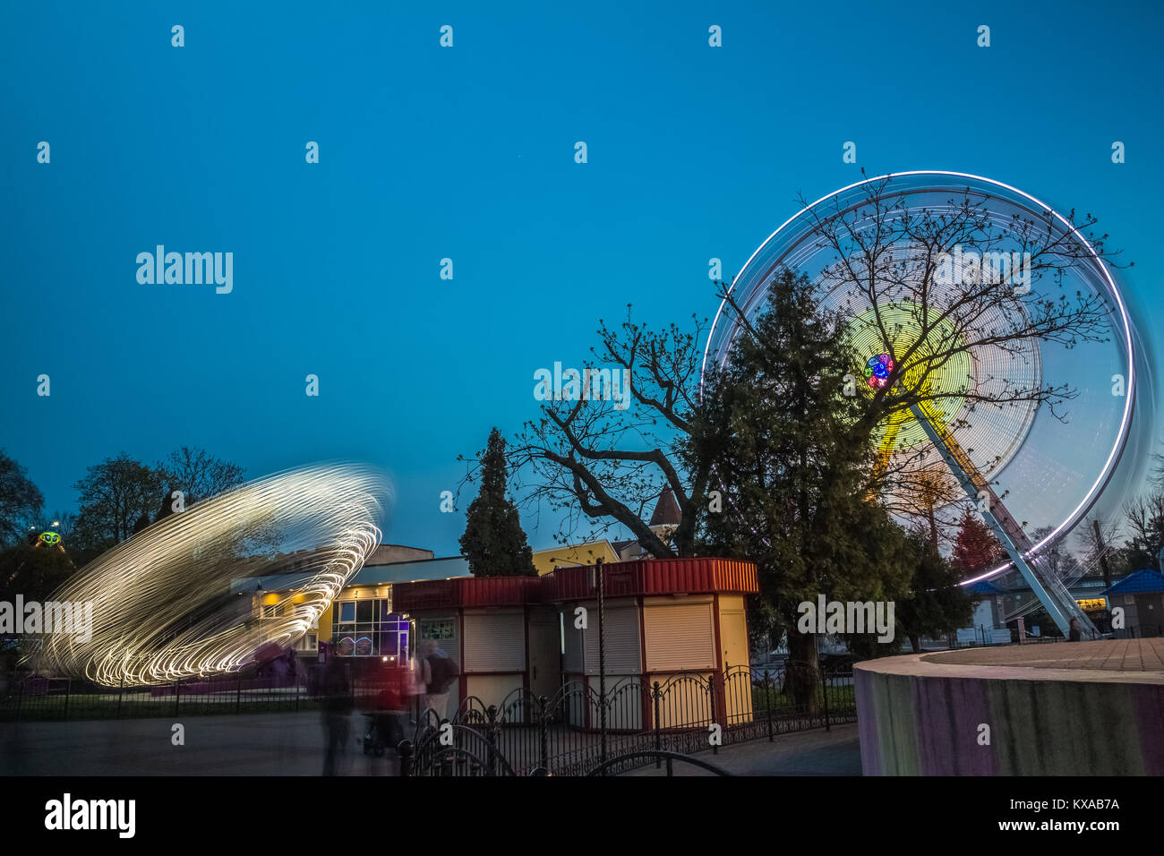 Two of the attraction in the amusement park on a long exposure Stock ...