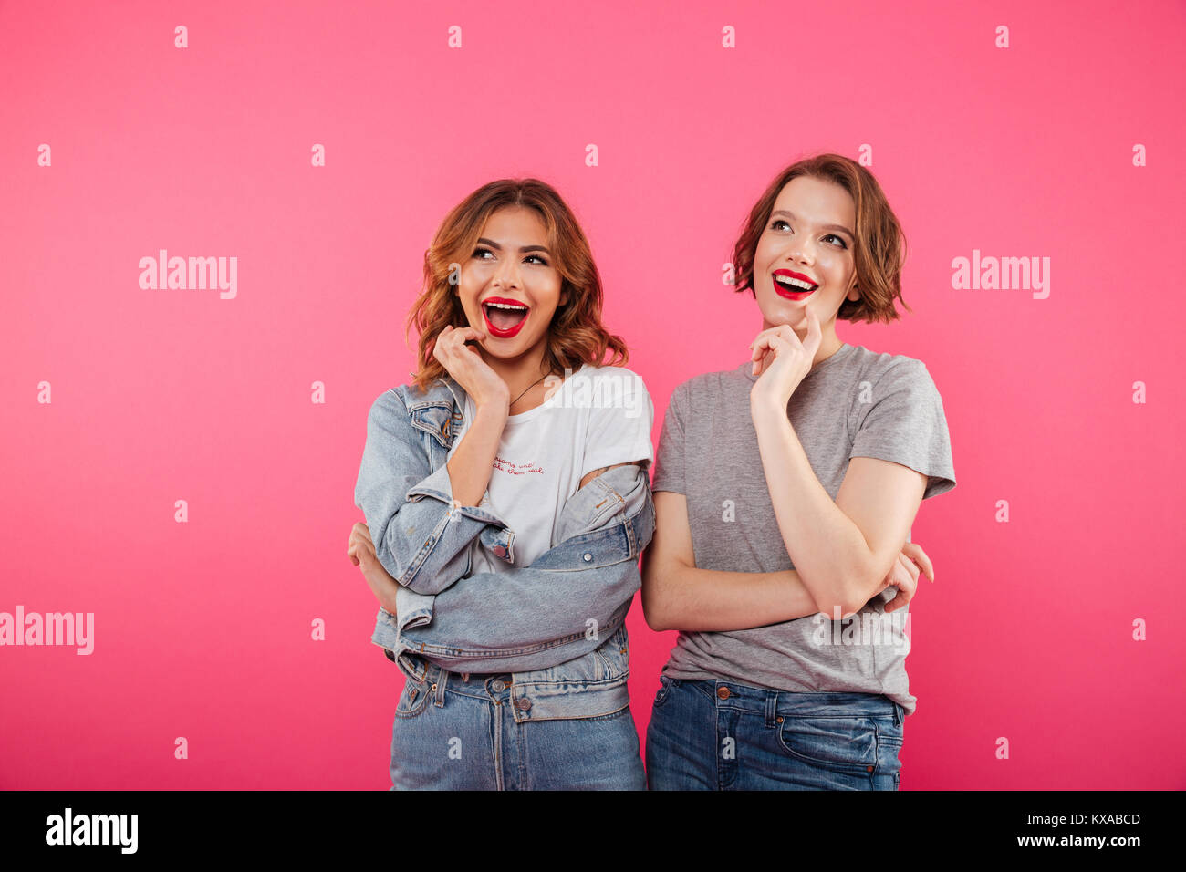 Picture of cheerful two women friends standing isolated over pink ...