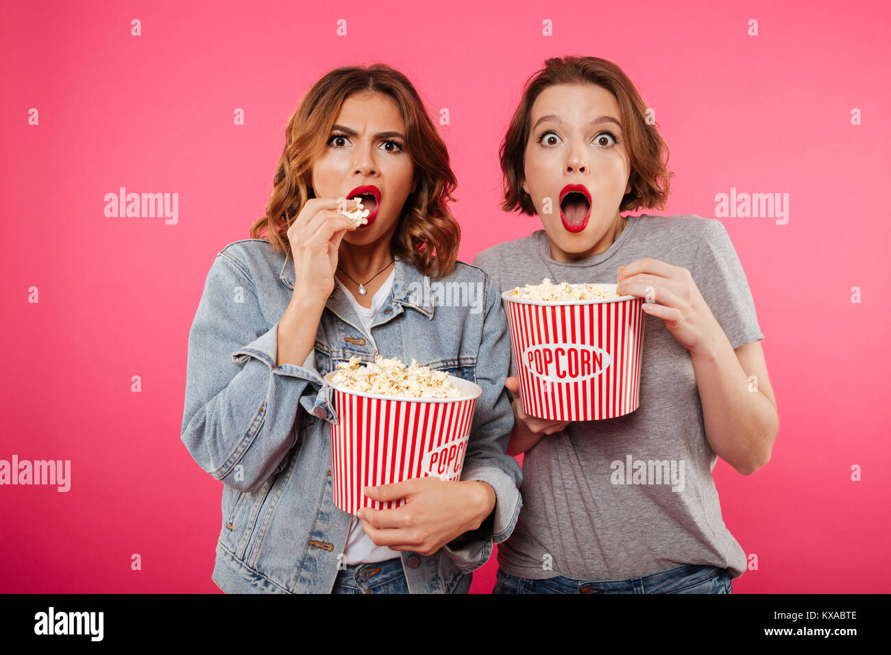 Photo of two shocked women friends standing isolated over pink ...