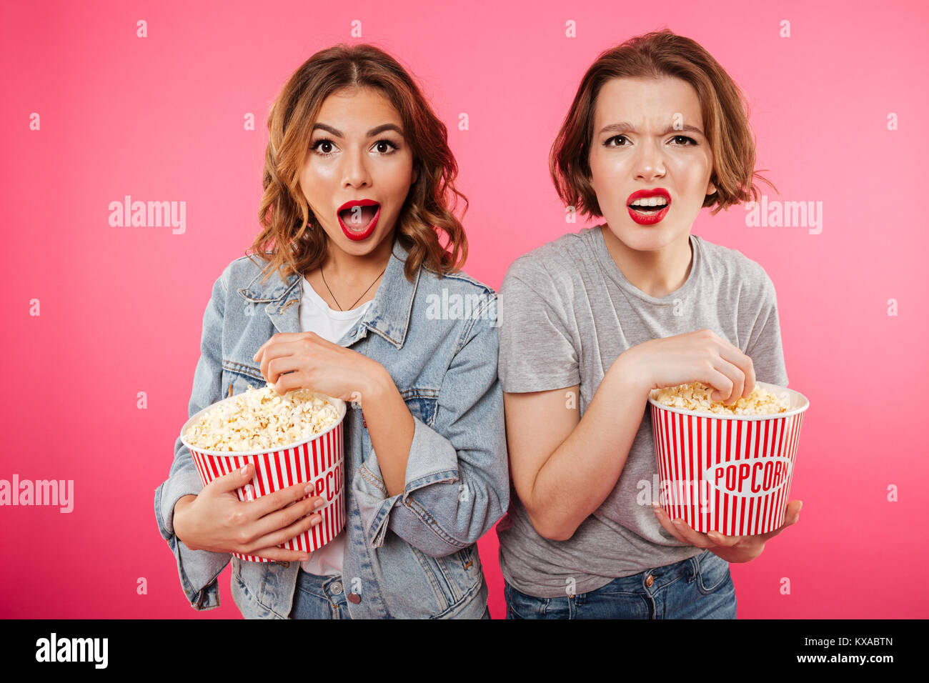 Photo of two shocked women friends standing isolated over pink ...