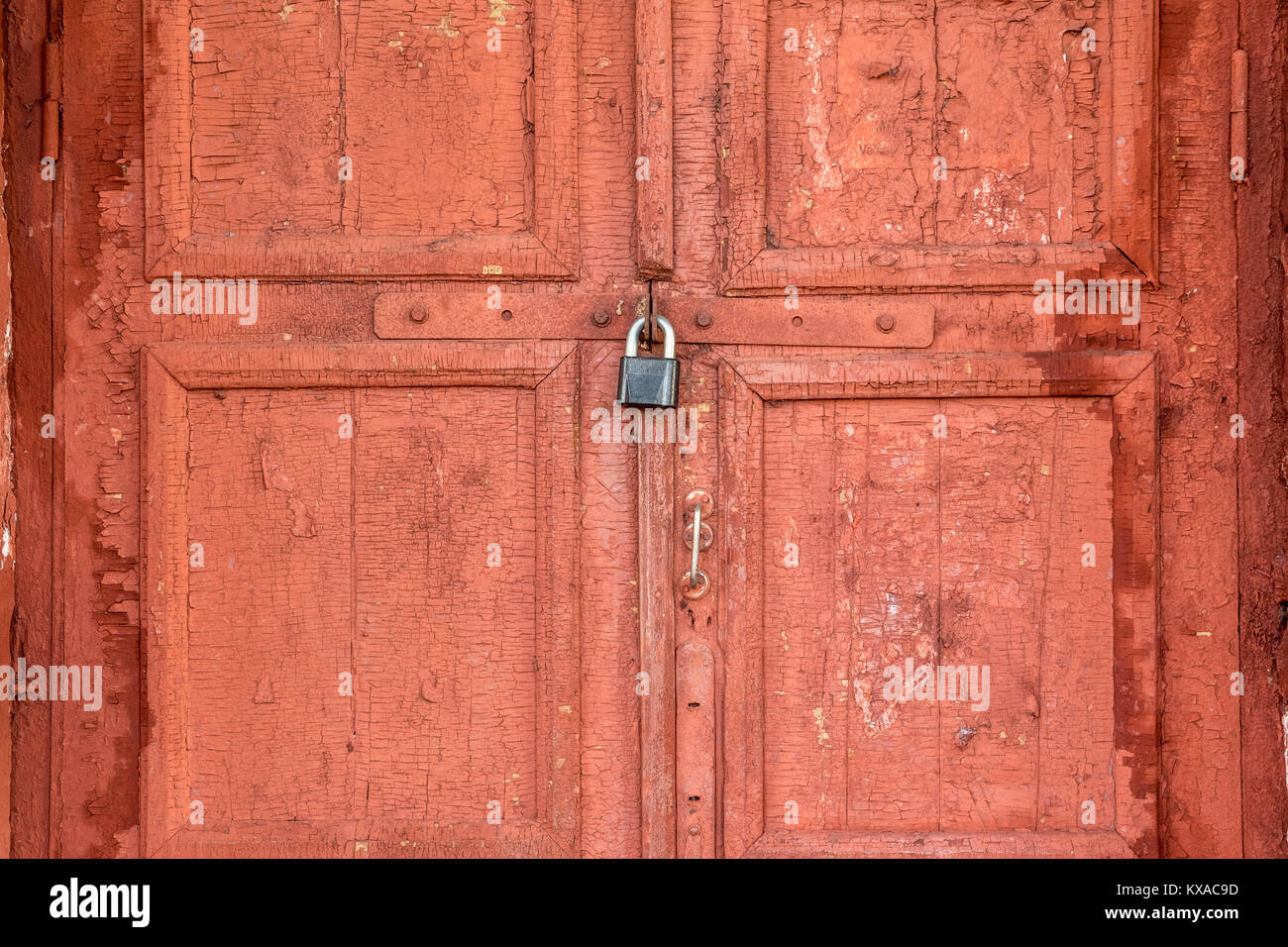 Old red door closed on the lock Stock Photo - Alamy