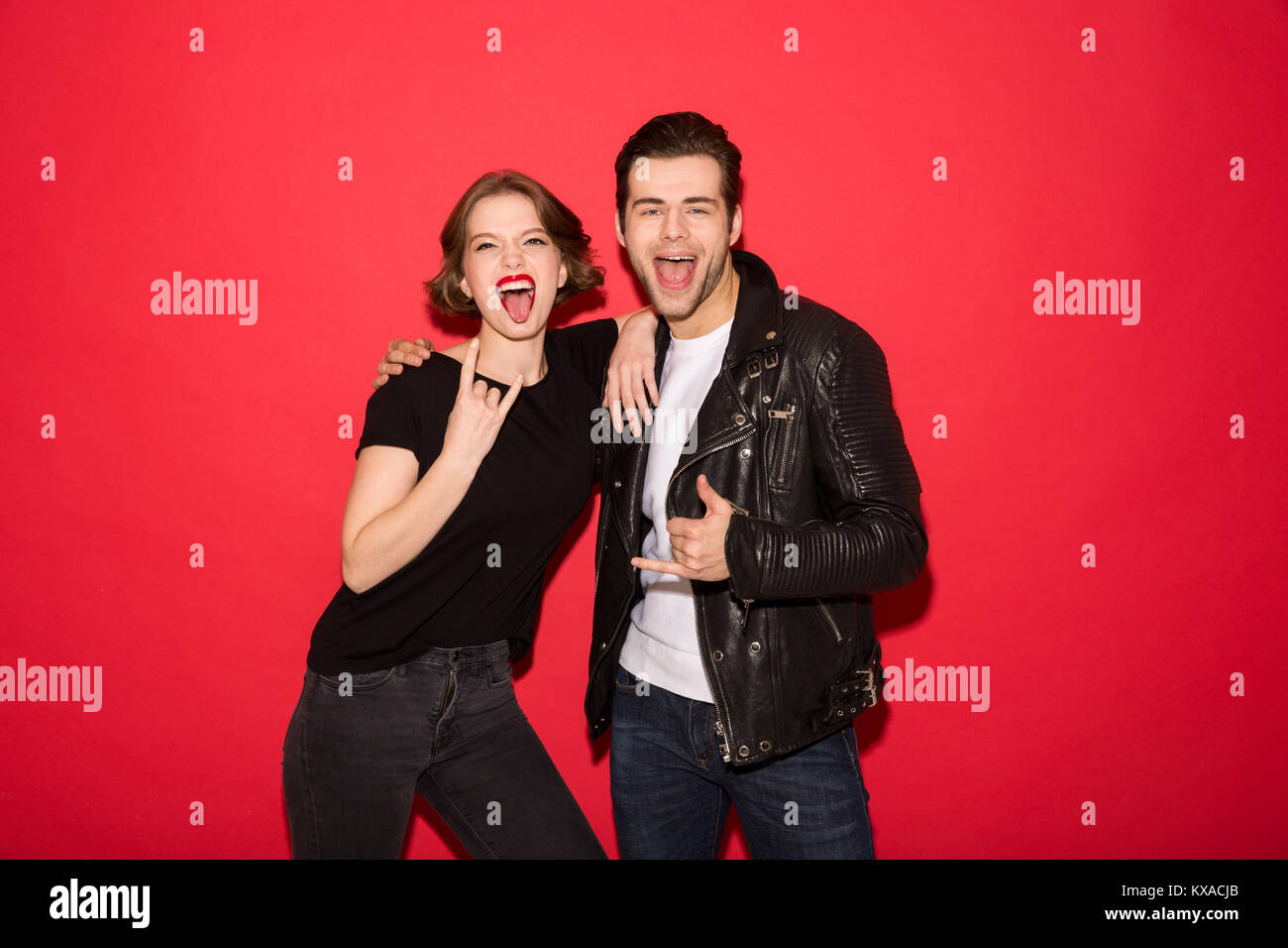 Image of laughing punk couple hugging and looking at the camera over ...