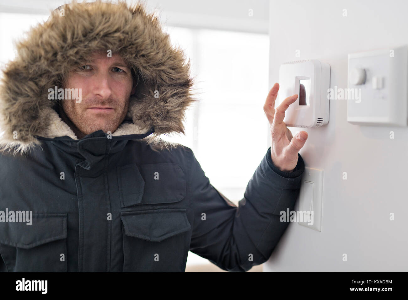 Man With Warm Clothing Feeling The Cold Inside House Stock Photo - Alamy