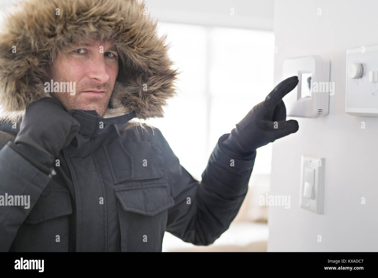 Man With Warm Clothing Feeling The Cold Inside House Stock Photo - Alamy