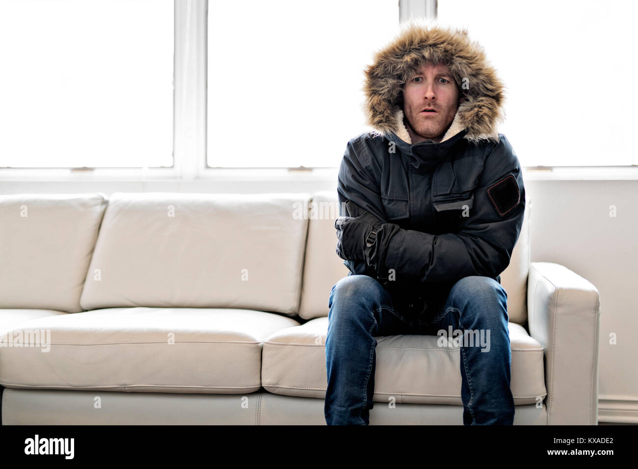 Man With Warm Clothing Feeling The Cold Inside House on the sofa Stock ...