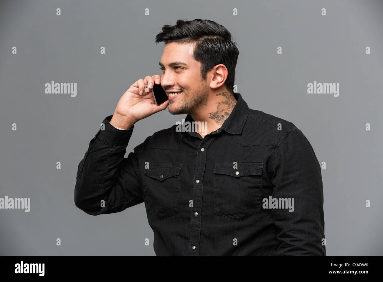 Image of handsome young cheerful man standing isolated over grey wall ...
