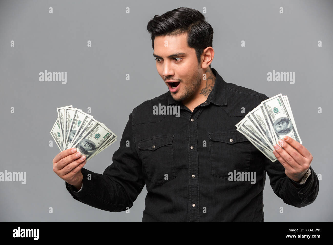 Image of handsome young shocked man standing isolated over grey wall ...