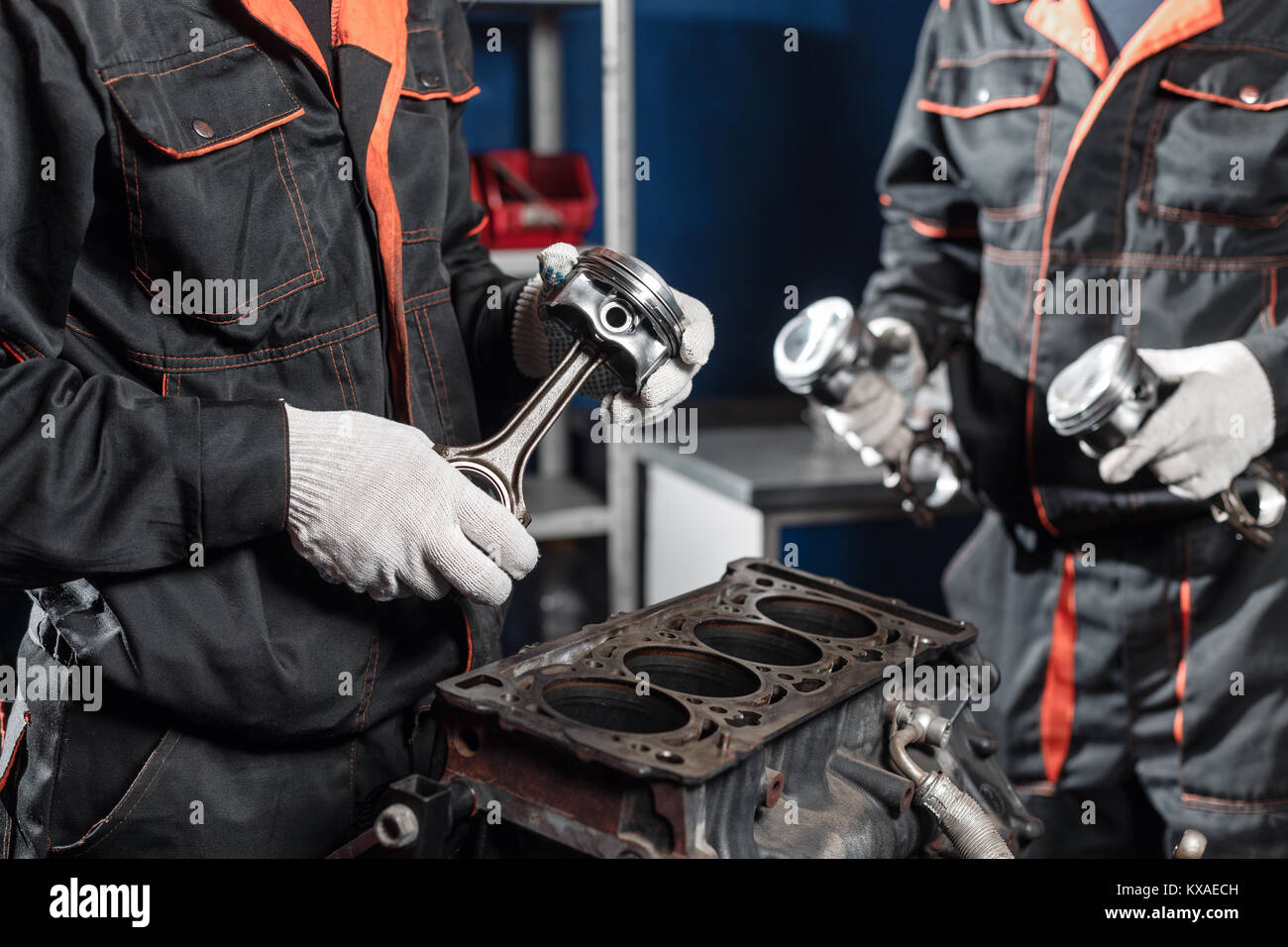 the mechanic installs a new piston. Disassemble engine block vehicle ...