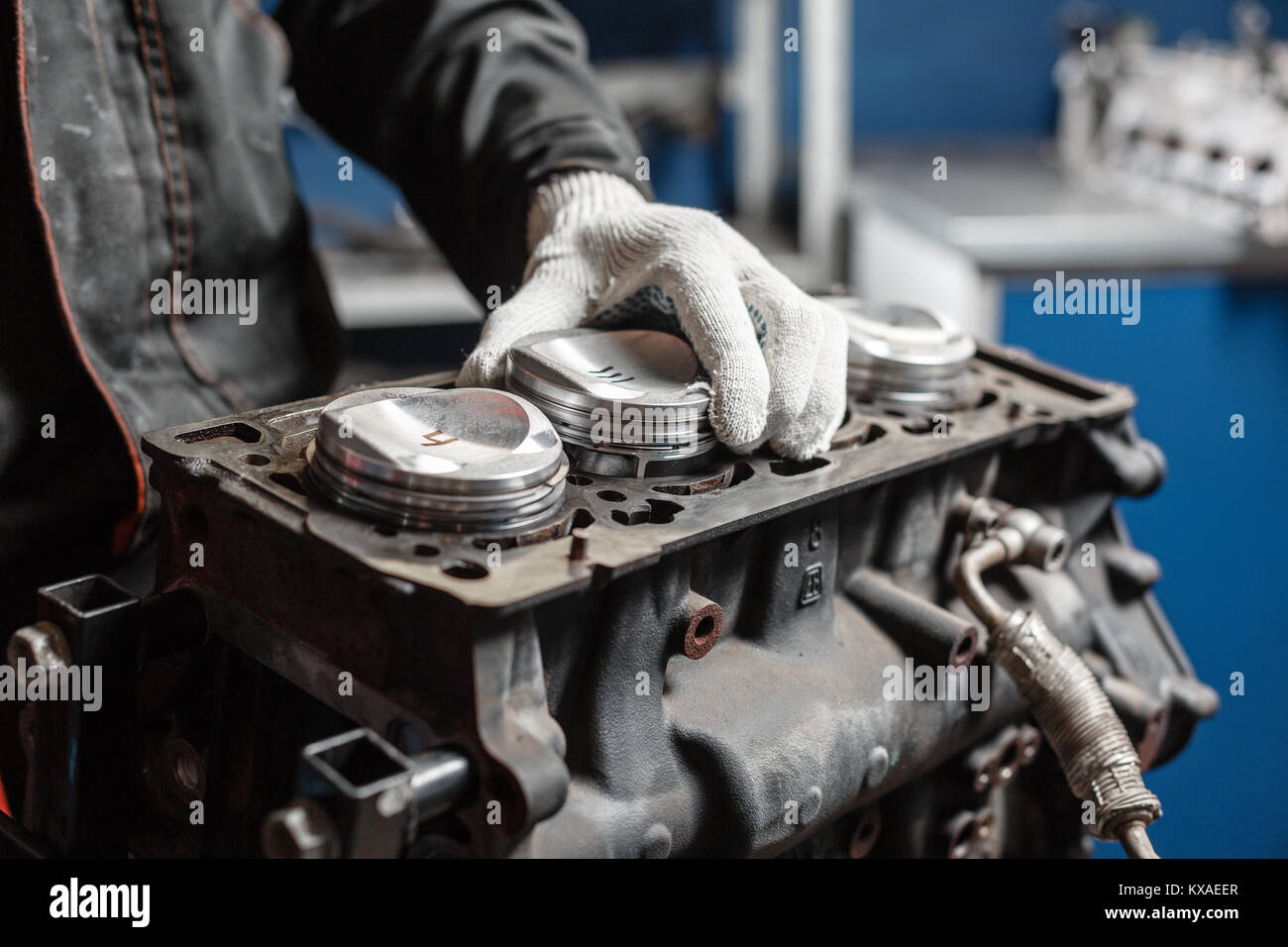 the mechanic installs a new piston. Disassemble engine block vehicle ...