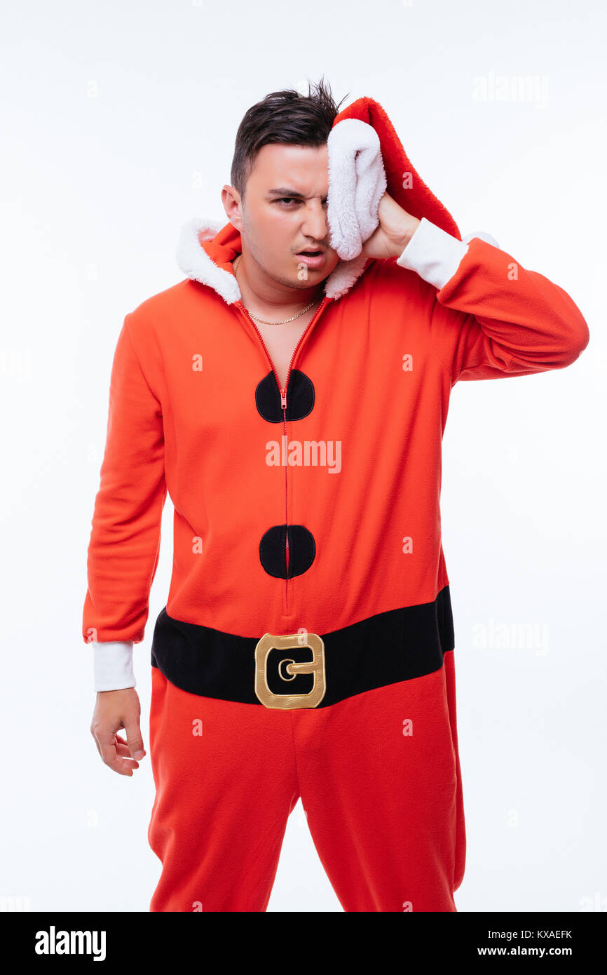 I am so tired. Frustrated Santa Claus holding head in hands and keeping ...