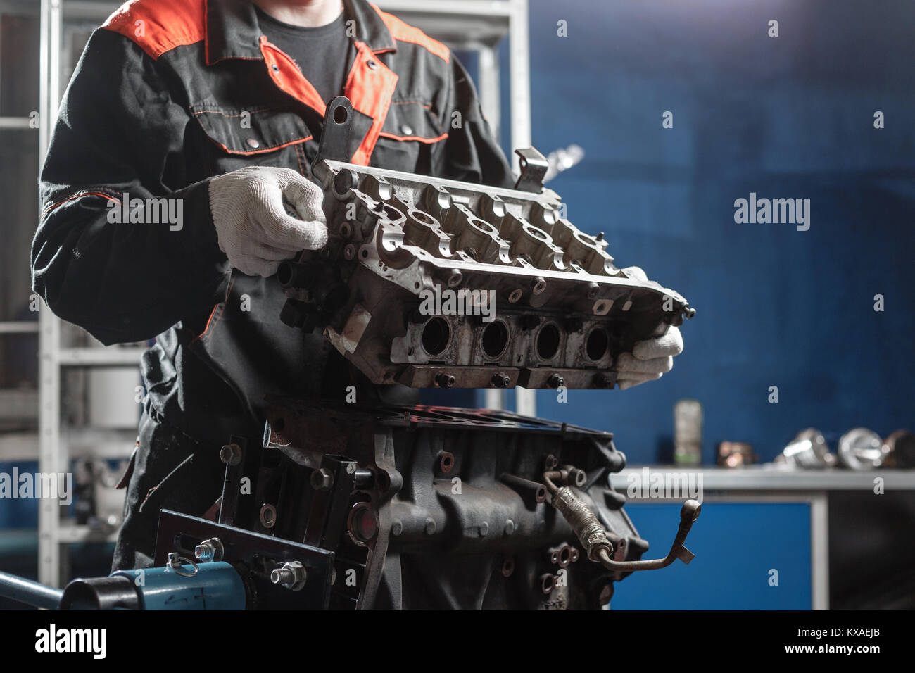 The mechanic disassemble block engine vehicle. Engine on a repair stand ...
