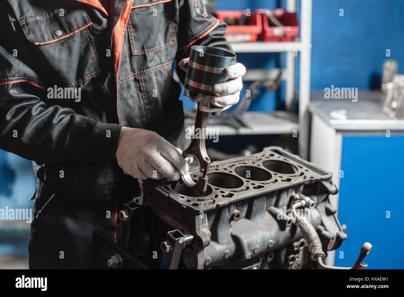 the mechanic installs a new piston. Disassemble engine block vehicle ...