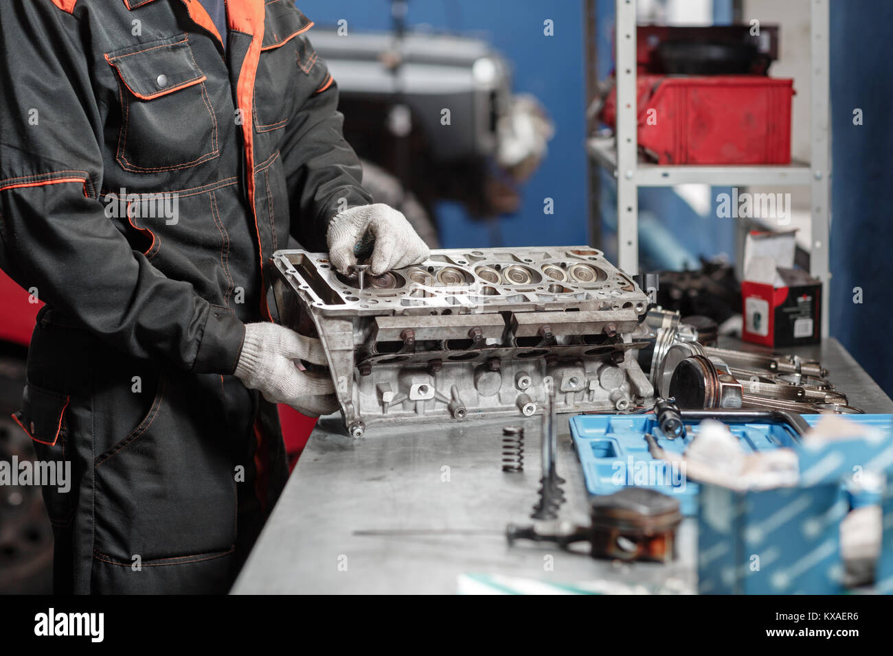 the mechanic installs a new valve. Disassemble engine block vehicle ...