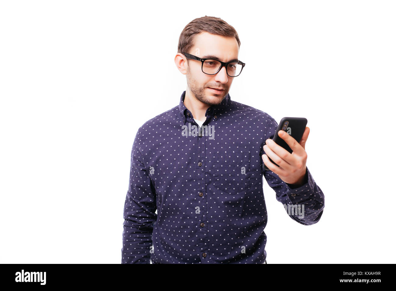 Typing text message. Smiling man with beard standing on white isolated ...