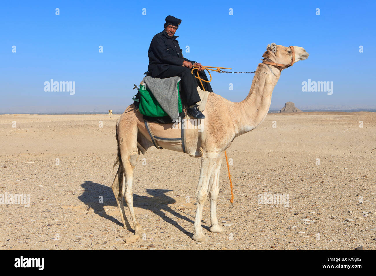 A mounted Egyptian police officer in front of the Black Pyramid of ...