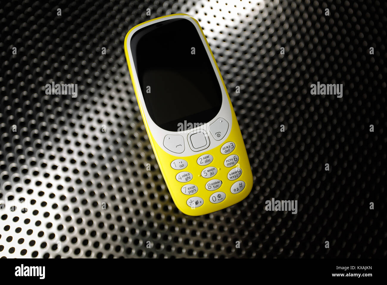 Yellow phone on metal surface Stock Photo - Alamy
