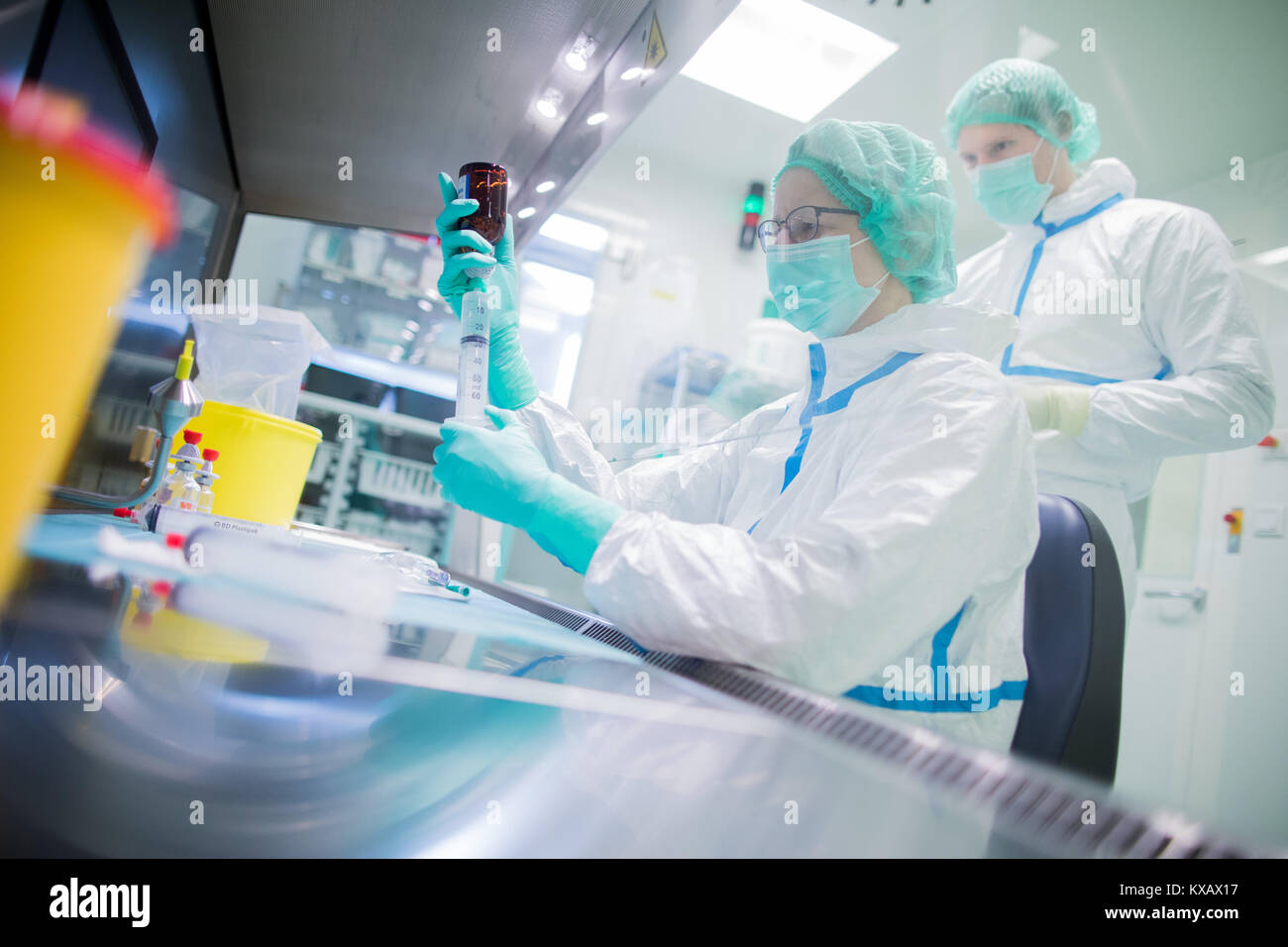 A pharmaceutical technical assistant and a pharmacist produce cander ...