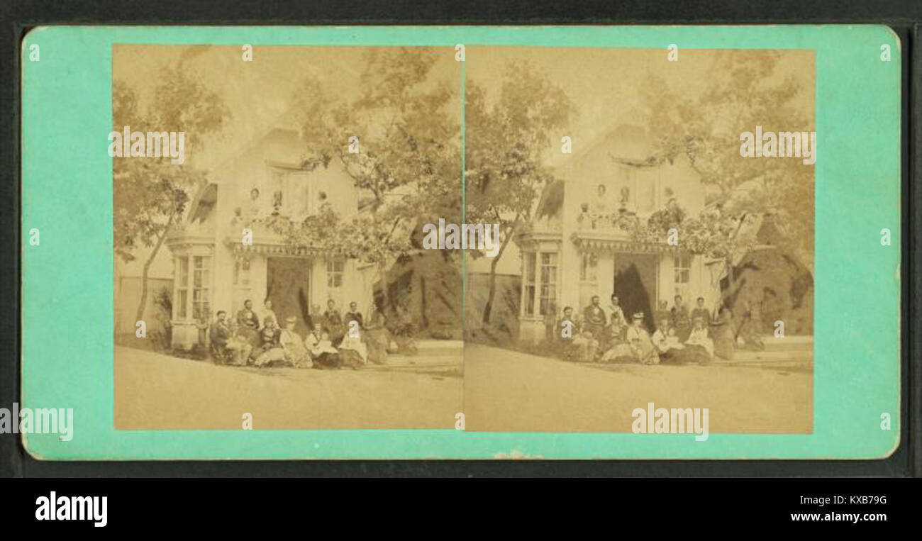 Photograph of a group of people gathered in front of a cottage, taken ...
