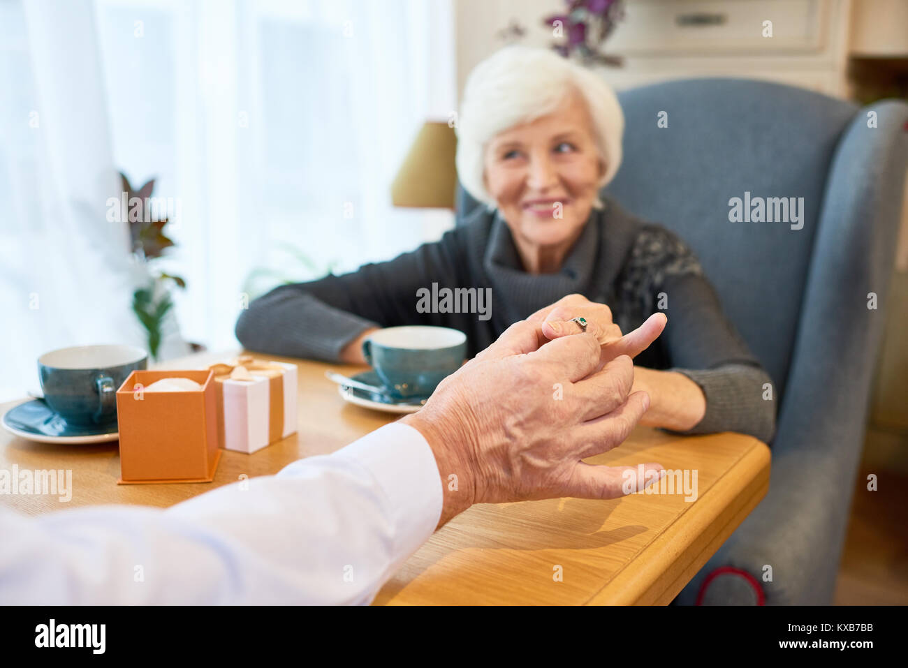 Putting Engagement Ring on Finger Stock Photo - Alamy
