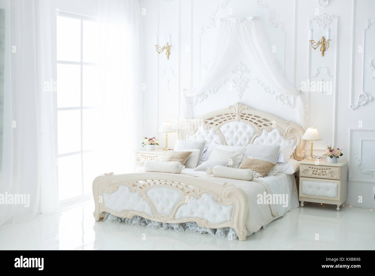 Beautiful light bedroom with a large beautiful bed Stock Photo - Alamy