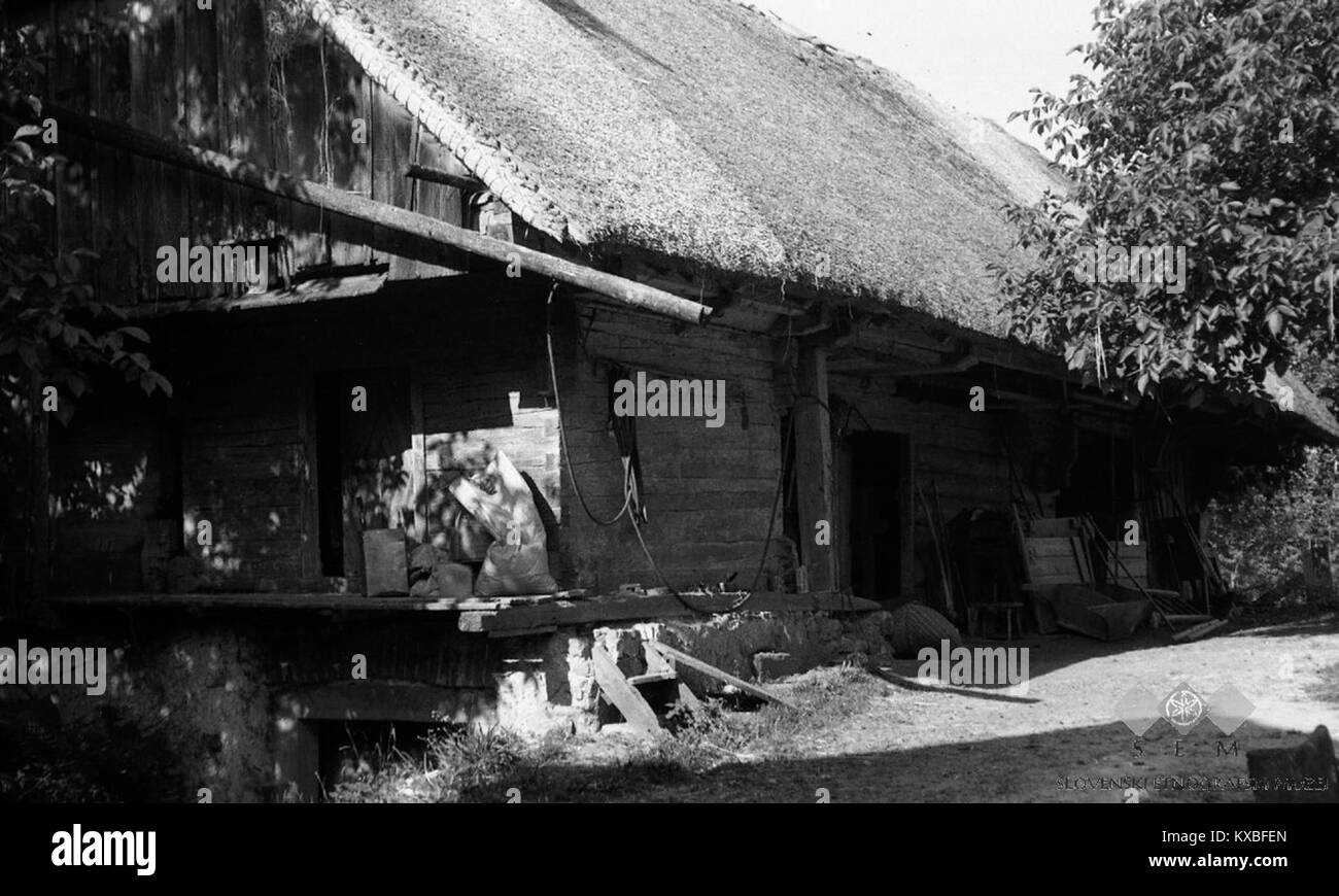 The photograph shows a historic building from 1828 alongside two barns ...