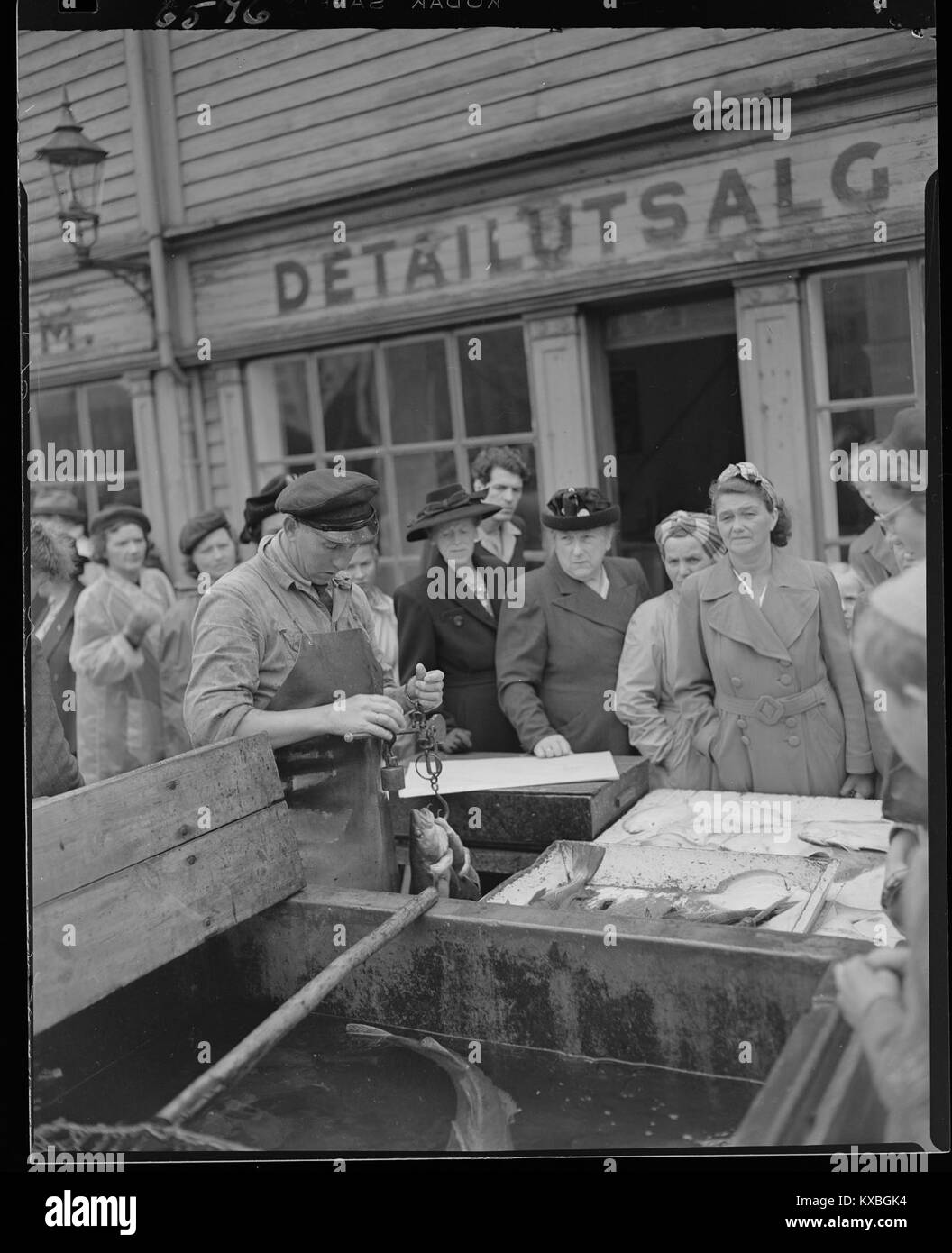 Photograph of a Norwegian fish market showing seafood stalls, workers ...