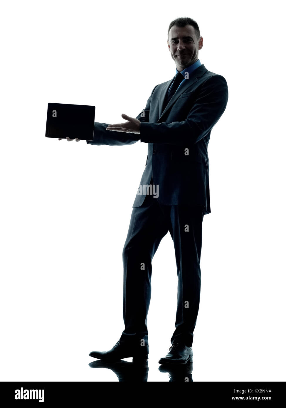 one caucasian business man standing showing digital tablet silhouette ... one caucasian business man standing showing digital tablet silhouette ...
